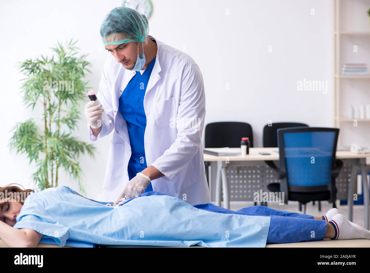 The female patient getting an injection in the clinic Stock Photo - Alamy