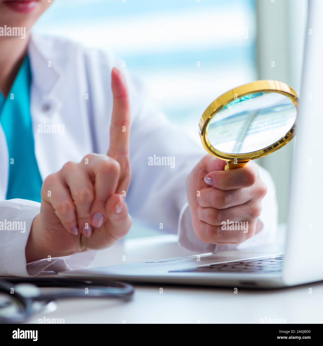 The doctor hand with magnifying glass Stock Photo - Alamy