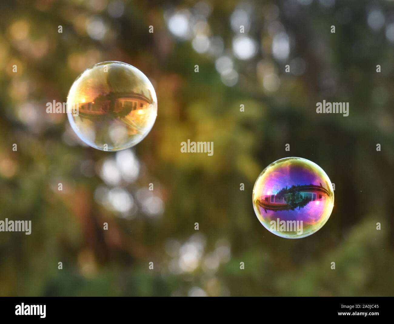 The reflection of a house in two soap bubbles Stock Photo - Alamy
