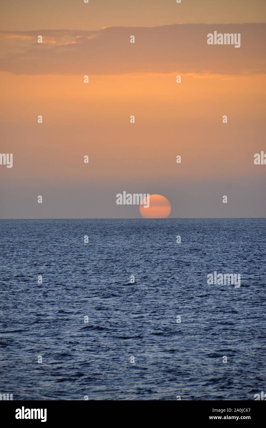 Sun sinking in the sea Stock Photo - Alamy