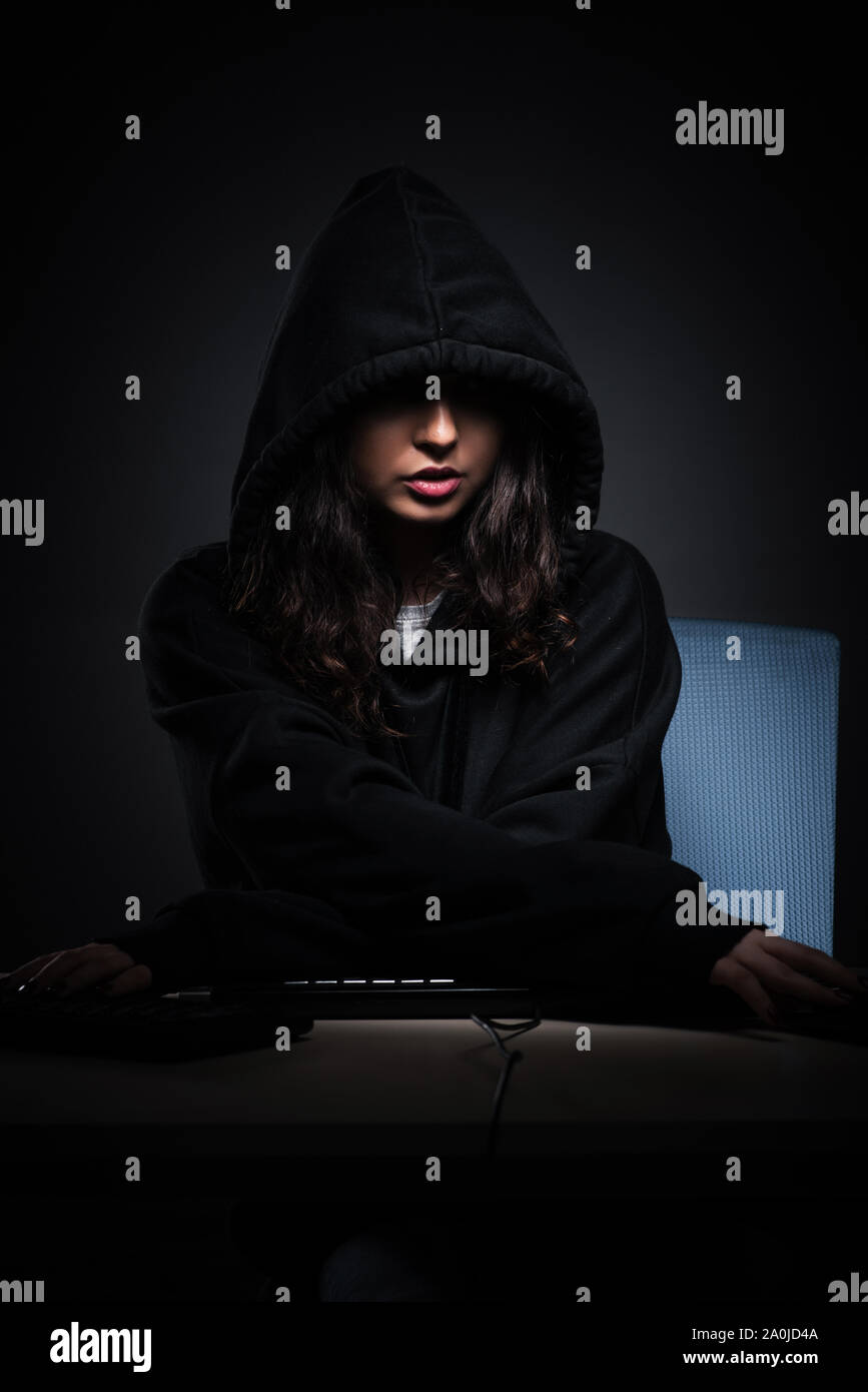 The female hacker hacking security firewall late in office Stock Photo ...