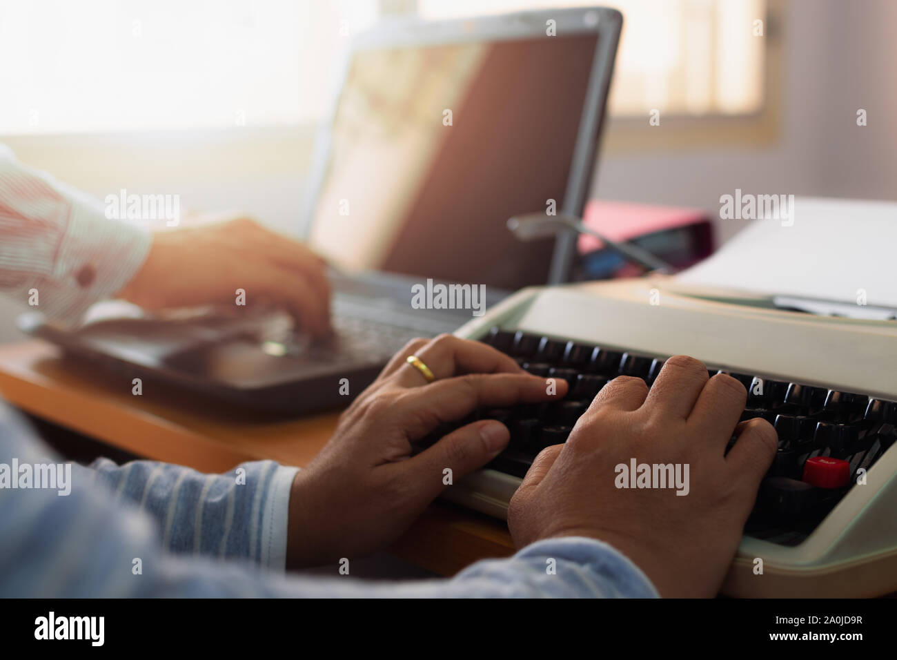 Hands of two workmate typing on working desk in office. Office life ...