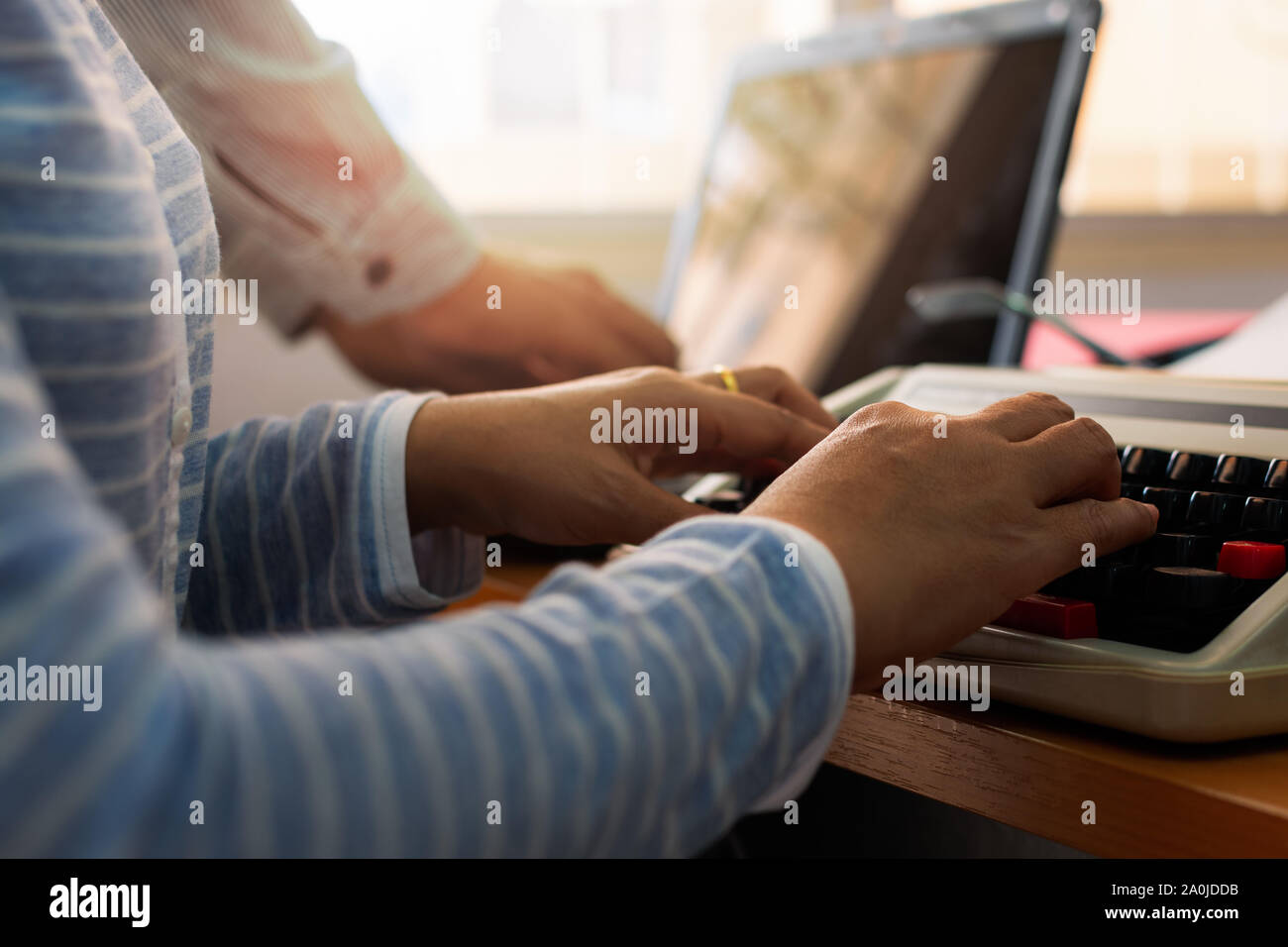 Hands of two workmate typing on working desk in office. Office life ...