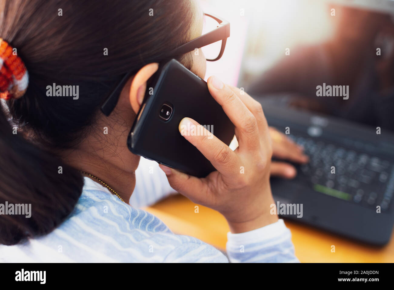 Woman holding mobile phone from behind hi-res stock photography and ...