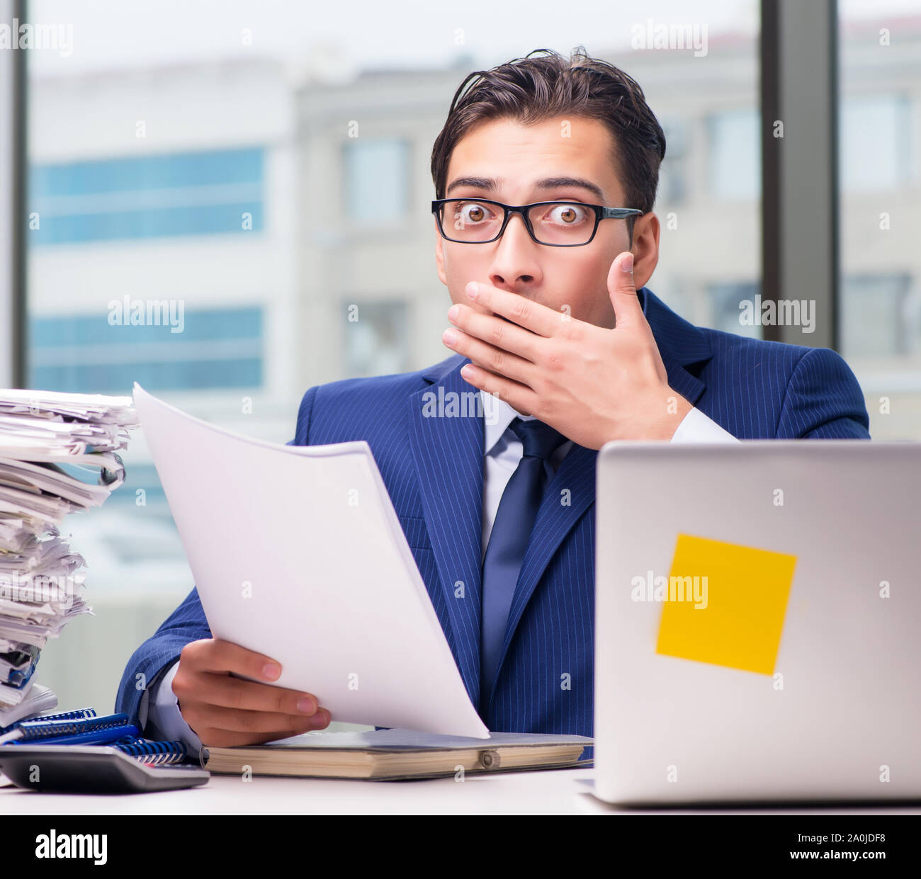 The workaholic businessman overworked with too much work in office ...