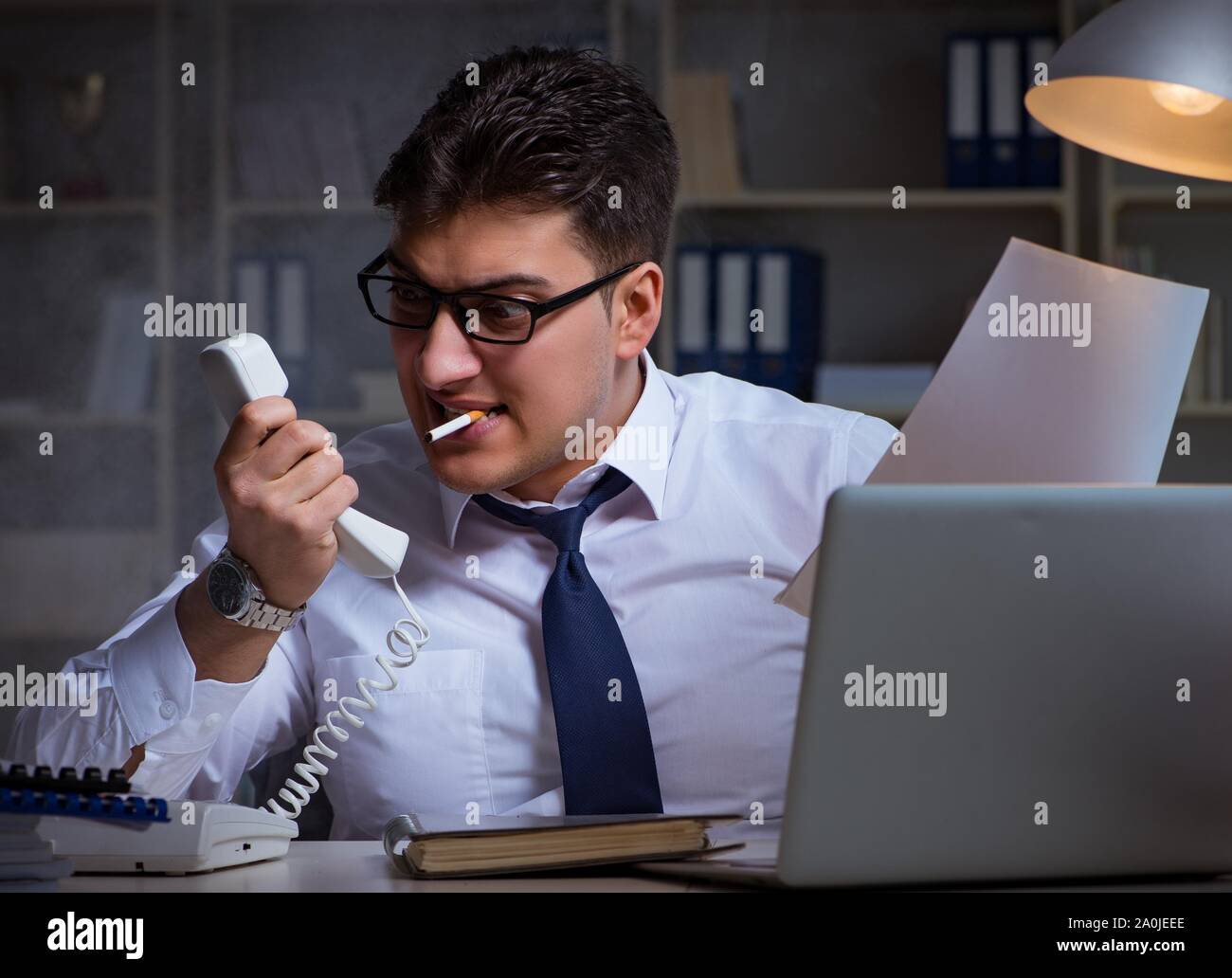 The businessman speaking on phone and smoking in office Stock Photo - Alamy
