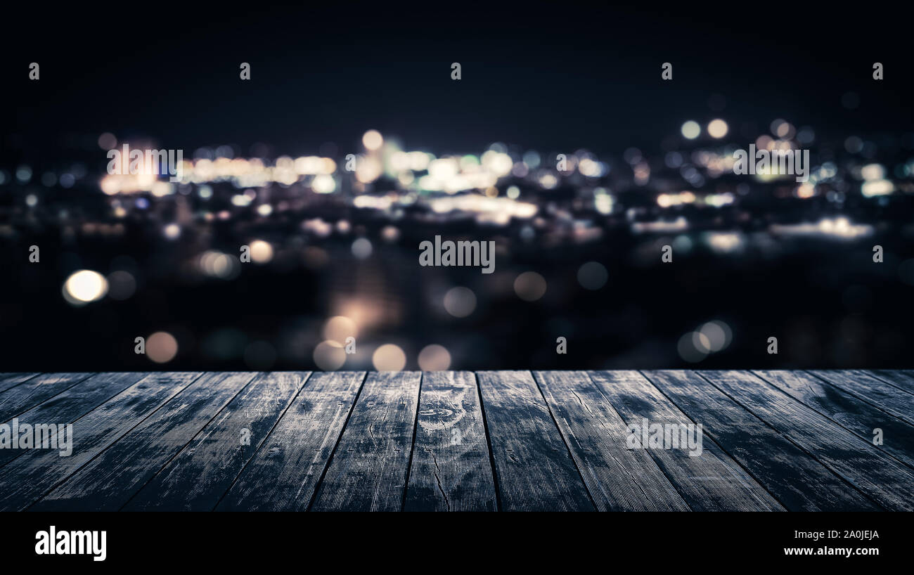 View from empty wooden plank floor above the town at night, For display ...