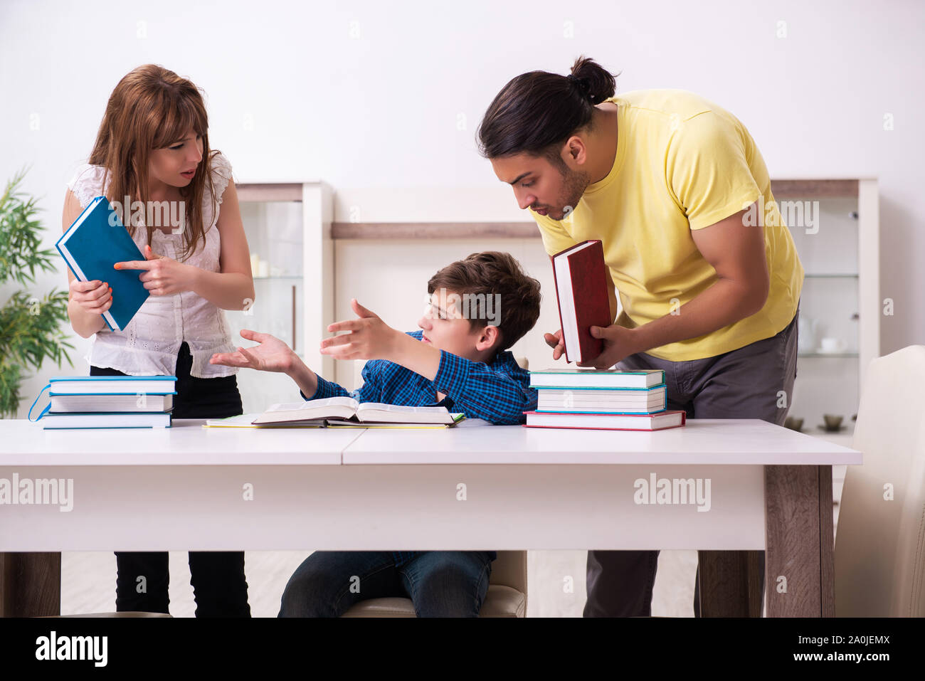 The parents helping their son to prepare for school Stock Photo - Alamy