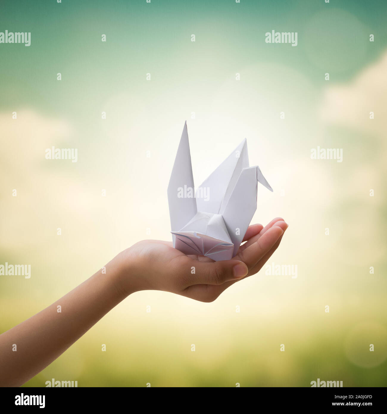 Origami bird on children's hand with beautiful natural background ...