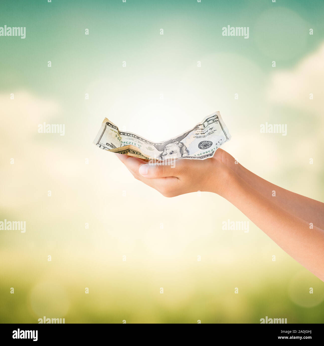 Hands holding crumpled US Dollars note with natural summer vintage ...