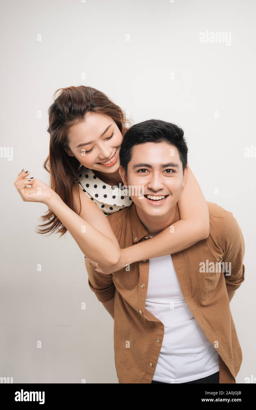 man carrying his lover on back, woman showing peace symbol over white ...