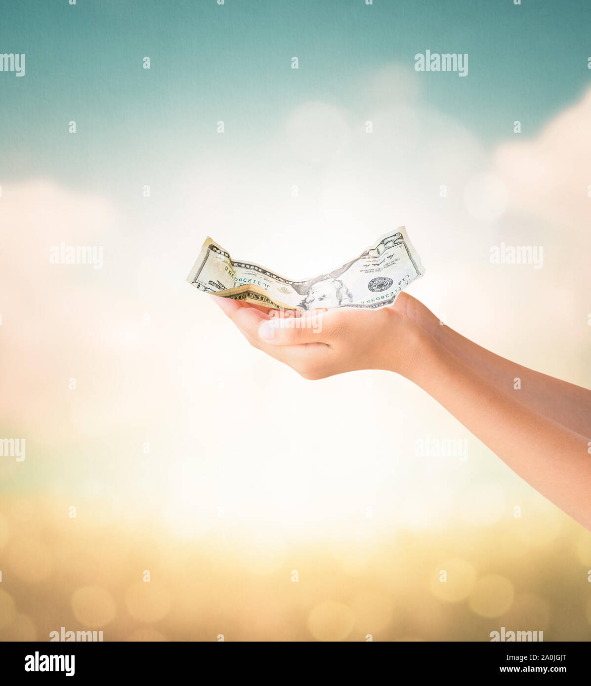 Hands holding crumpled US Dollars note with natural summer vintage ...