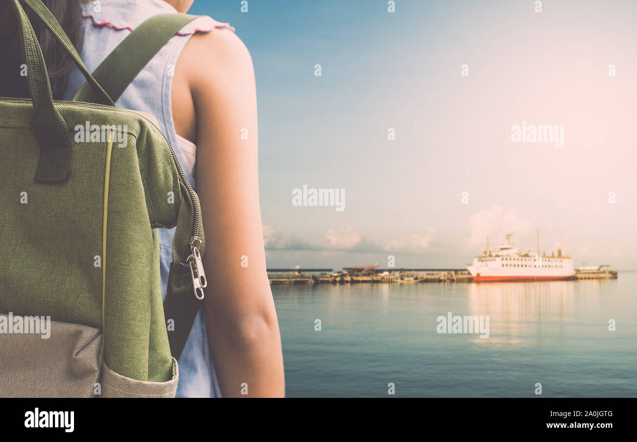 Girl with backpack waiting for a cruise ship at sea port, Travel ...