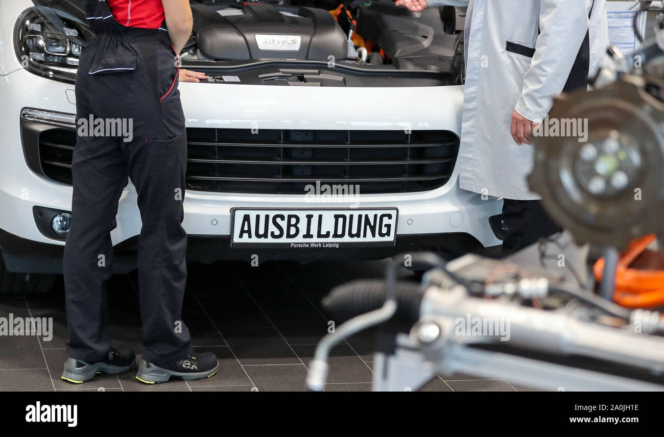 Car mechatronics technician explains on the computer the car diagnostic ...
