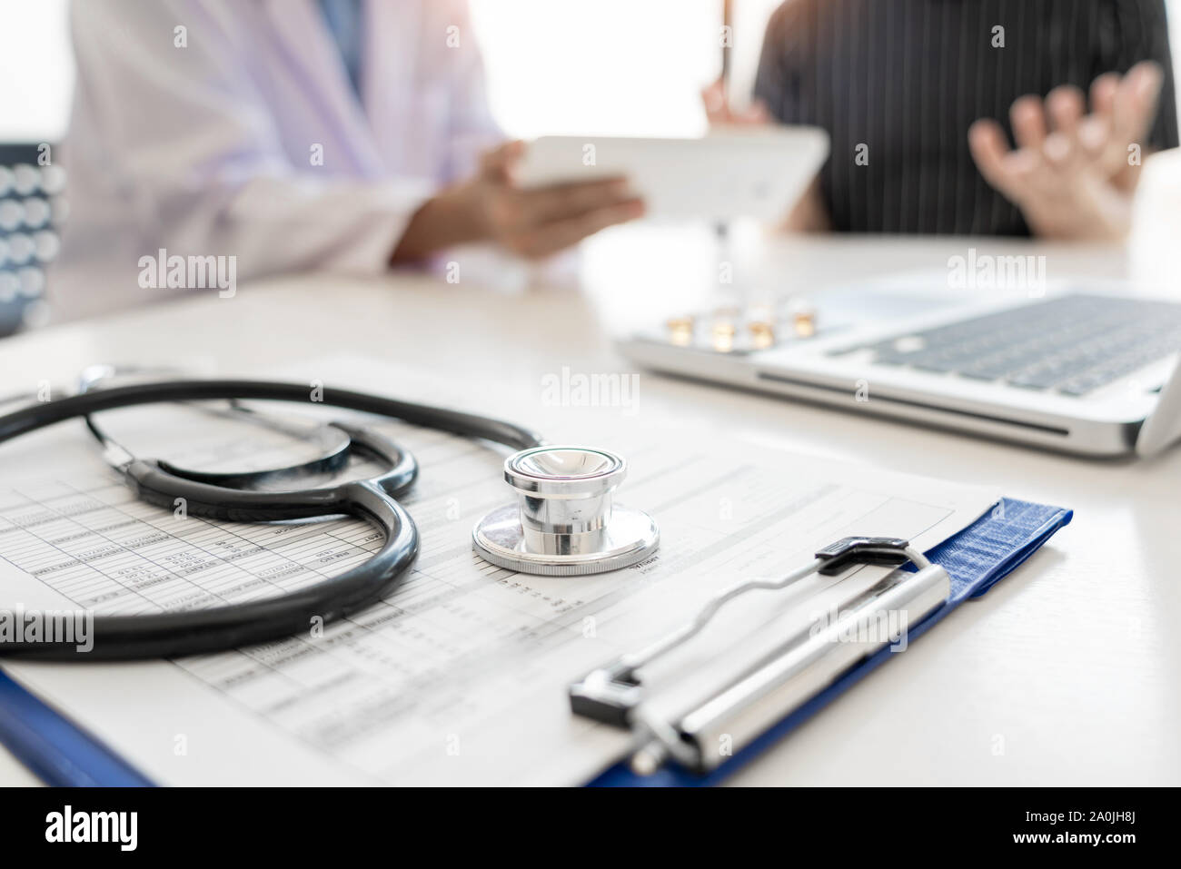 Doctor explaining for patient and showing medical records informations ...