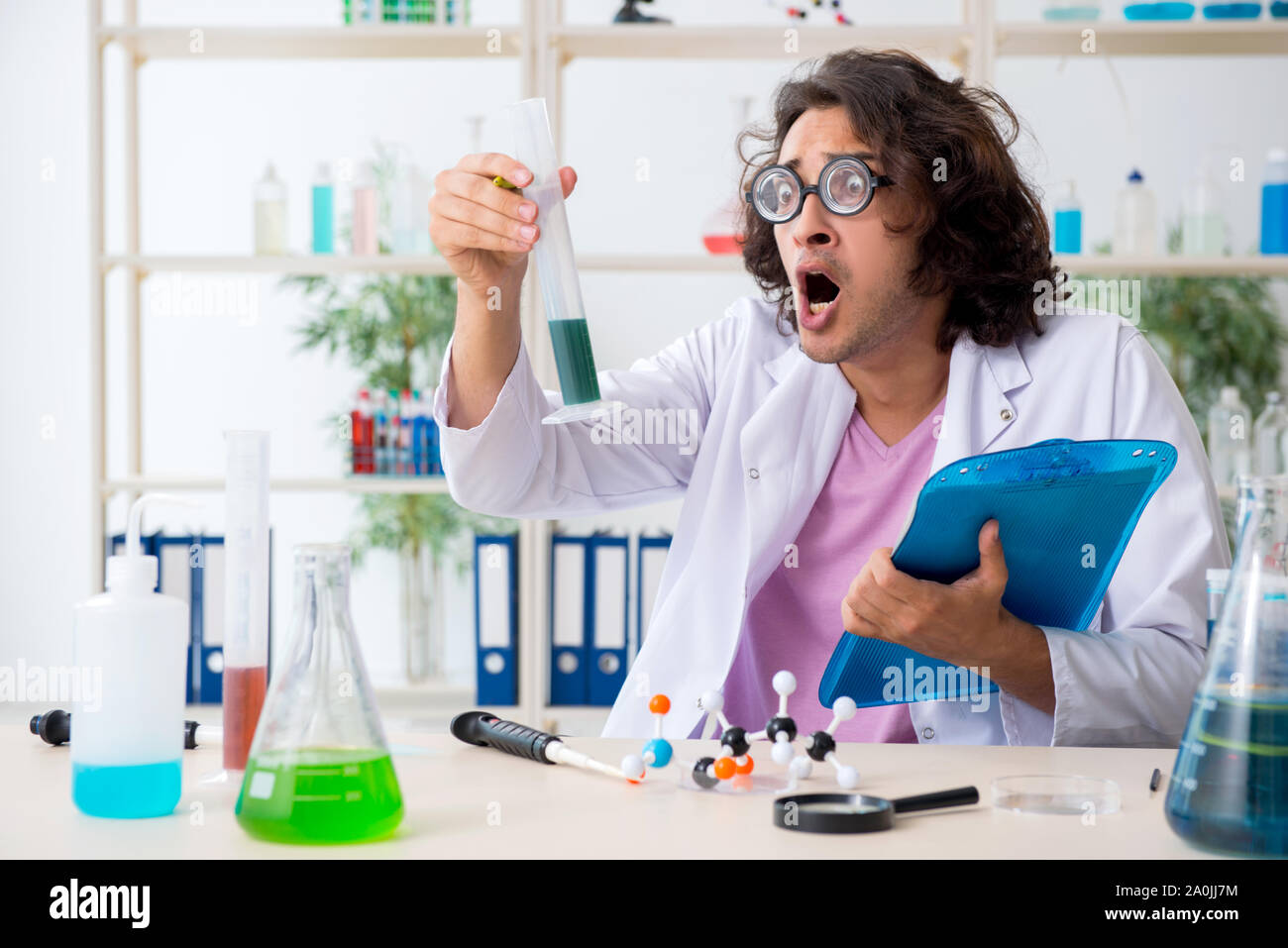The funny male chemist working in the lab Stock Photo - Alamy