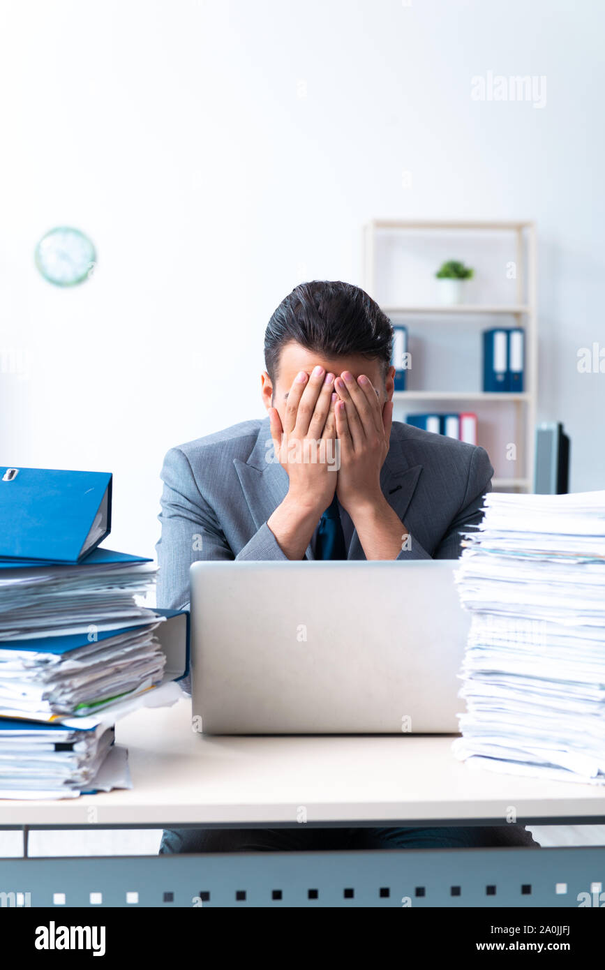 The businessman with heavy paperwork workload Stock Photo - Alamy