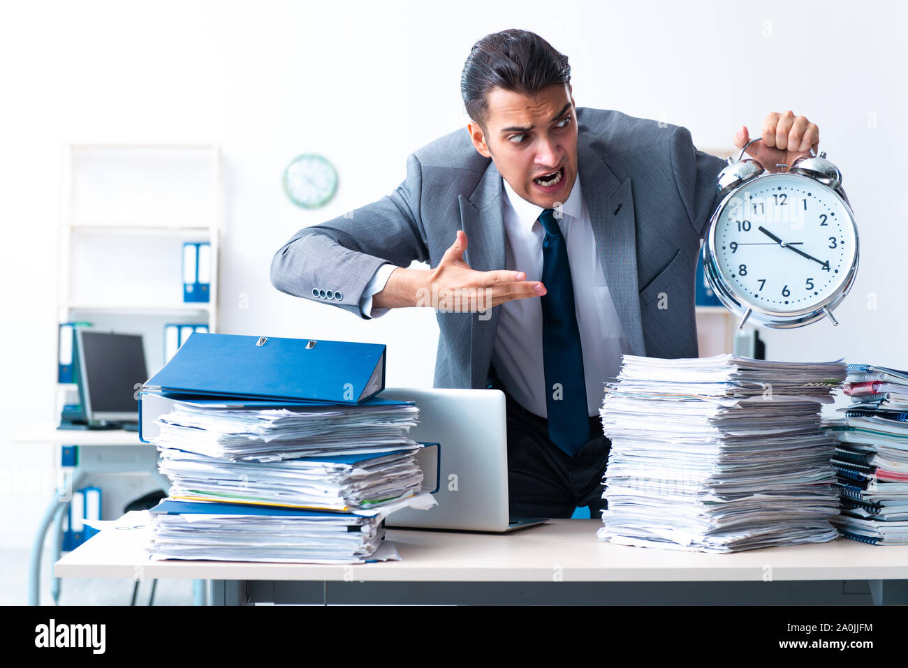 The businessman with heavy paperwork workload Stock Photo - Alamy
