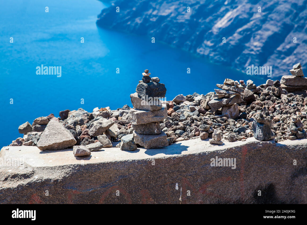 Cairns of rocks at the walking path number 9 between the cities of Fira ...