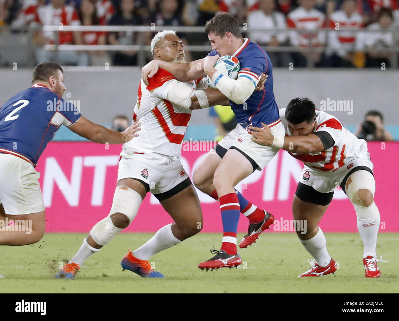 Japan's Isileli Nakajima (2nd from L) and Koo Ji Won (R) tackle a ...