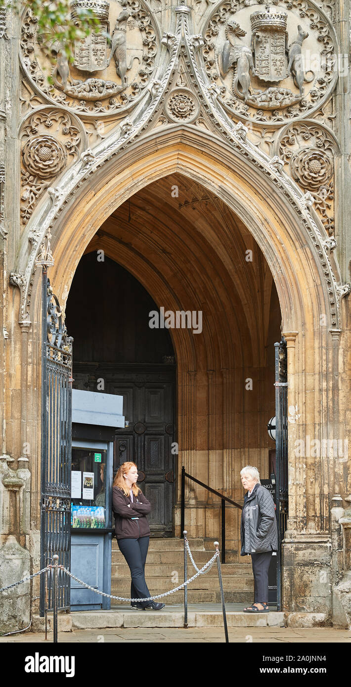 Two female gatekeepers stand at the entrance to the chapel at King's ...