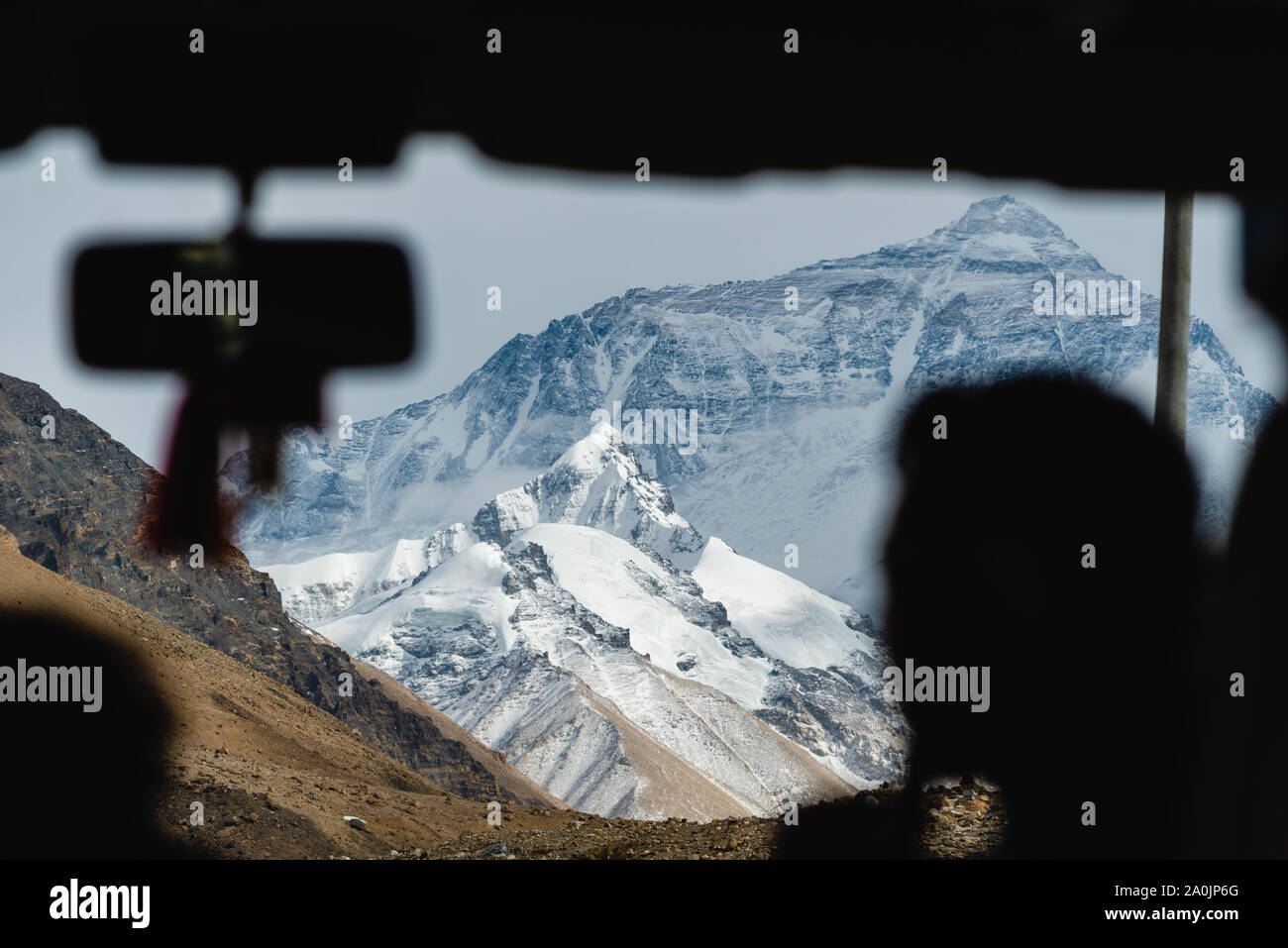 The towering peak of Mount Everest looms through the bus window as ...