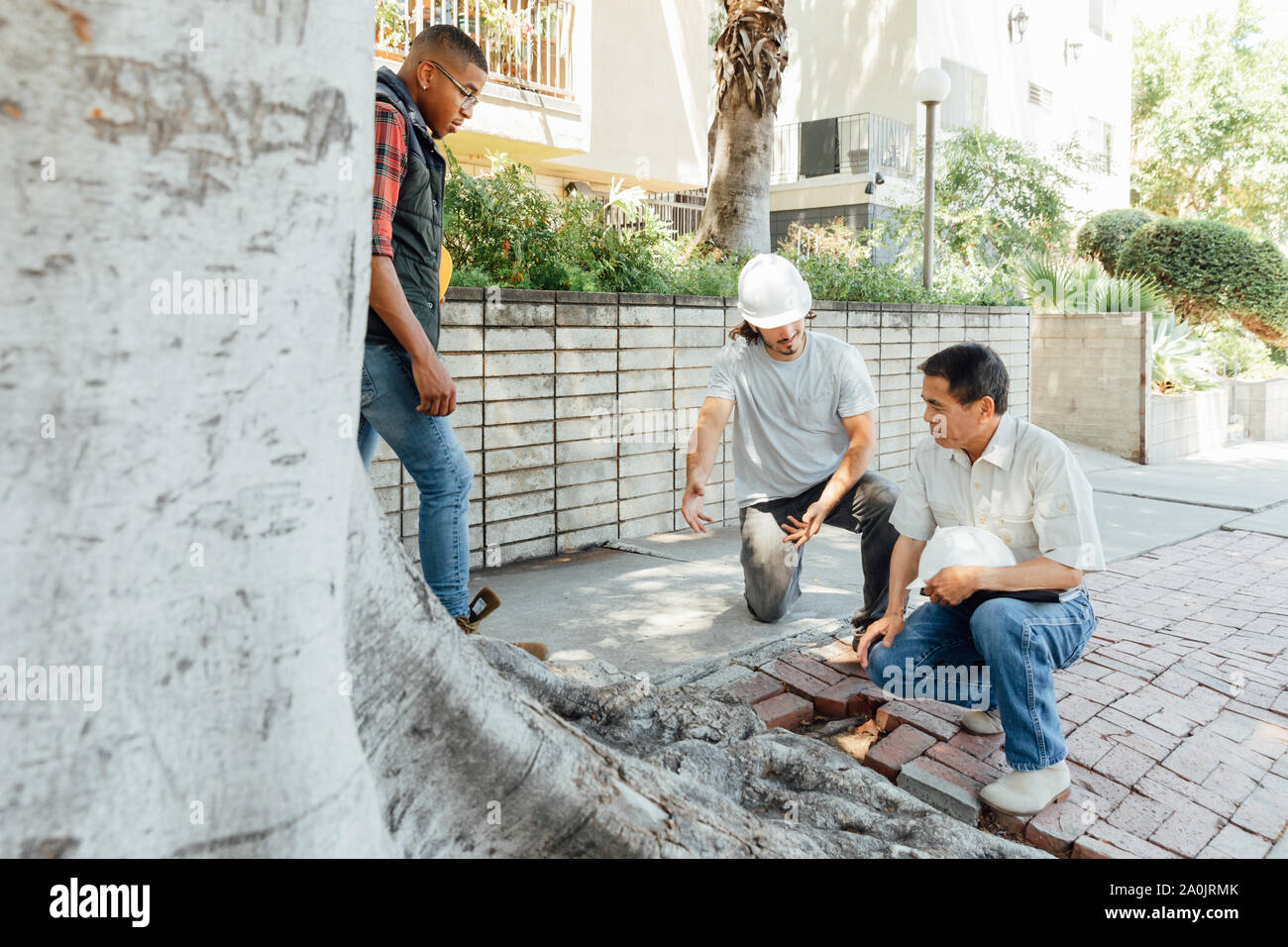 Men working together outside Stock Photo - Alamy