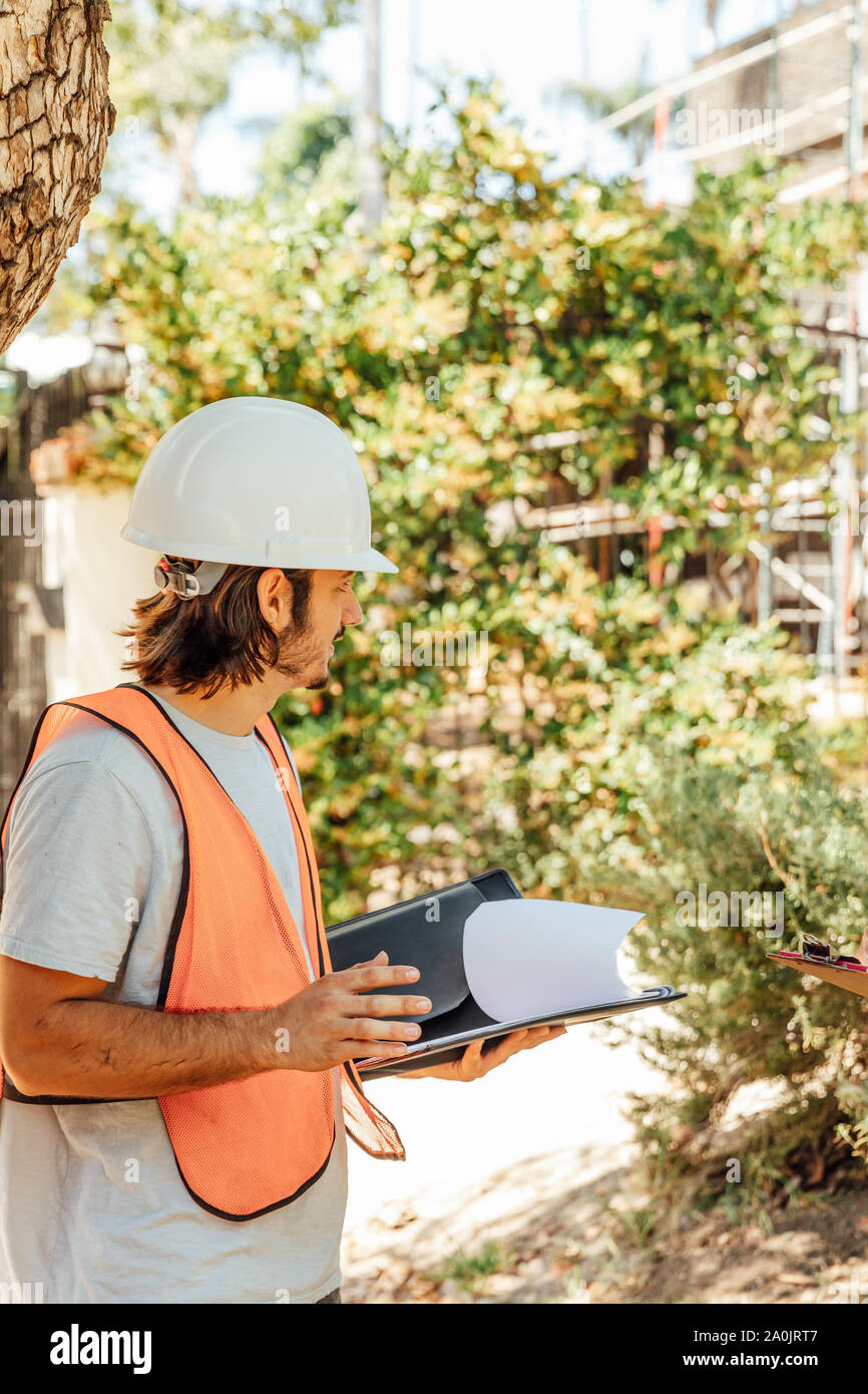 Man working outside with clipboard Stock Photo - Alamy