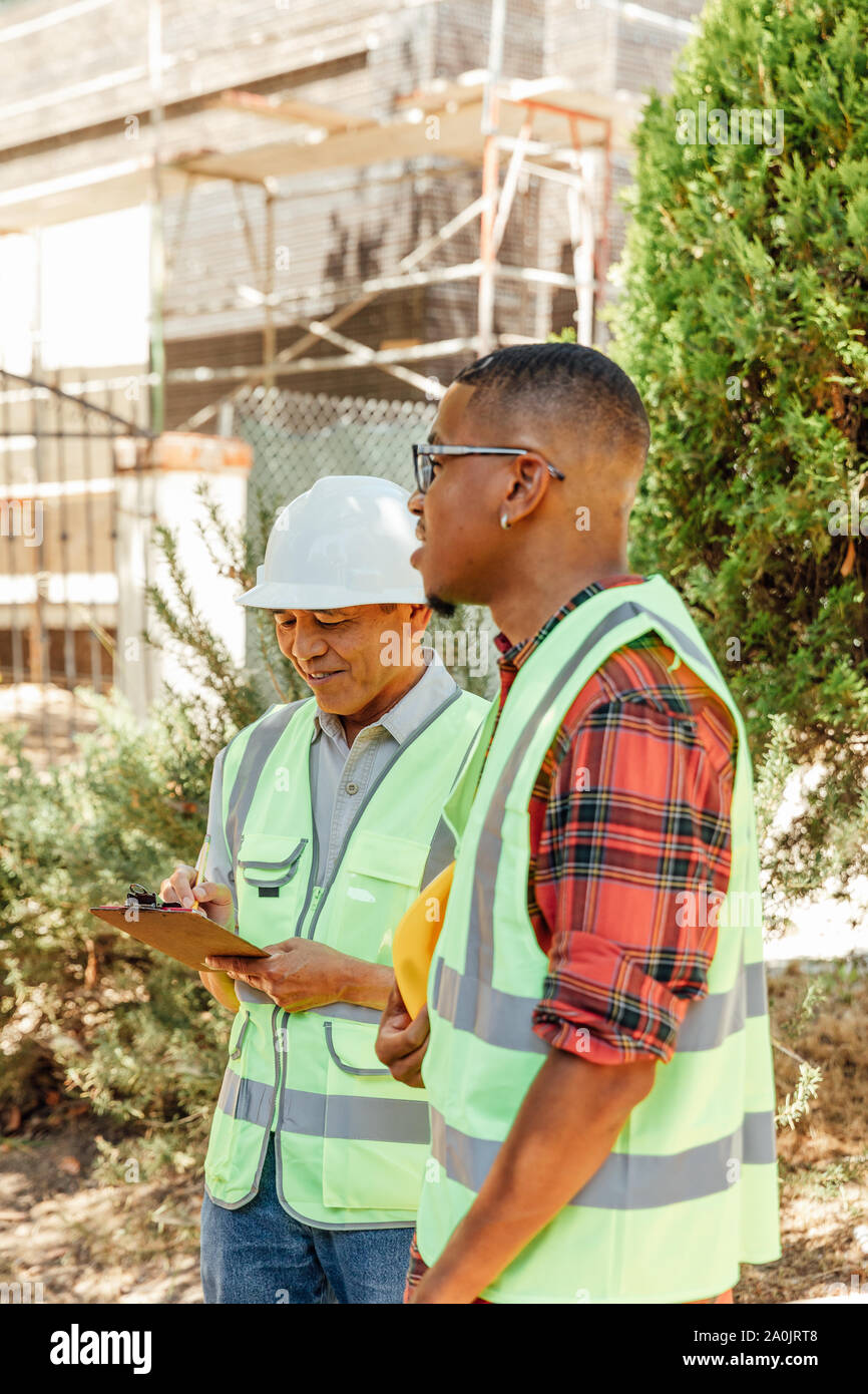 Men working together outside Stock Photo - Alamy