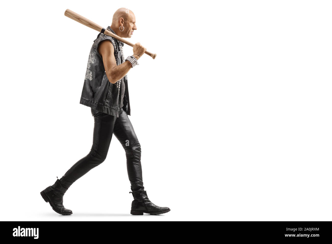 Full length profile shot of a dangerous man in leather clothes walking ...