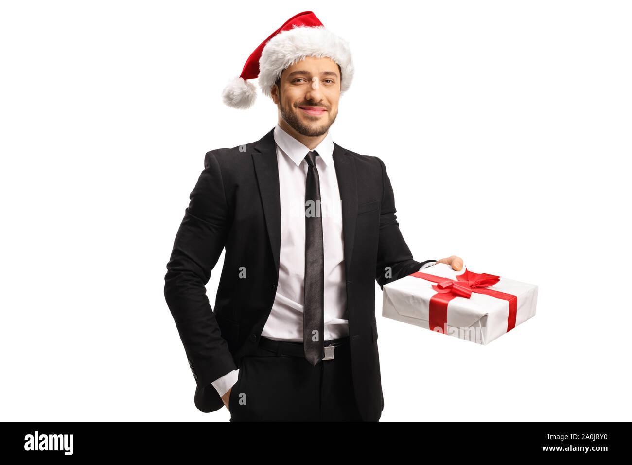 Young handsome man in a suit with a christmas hat holding a present ...