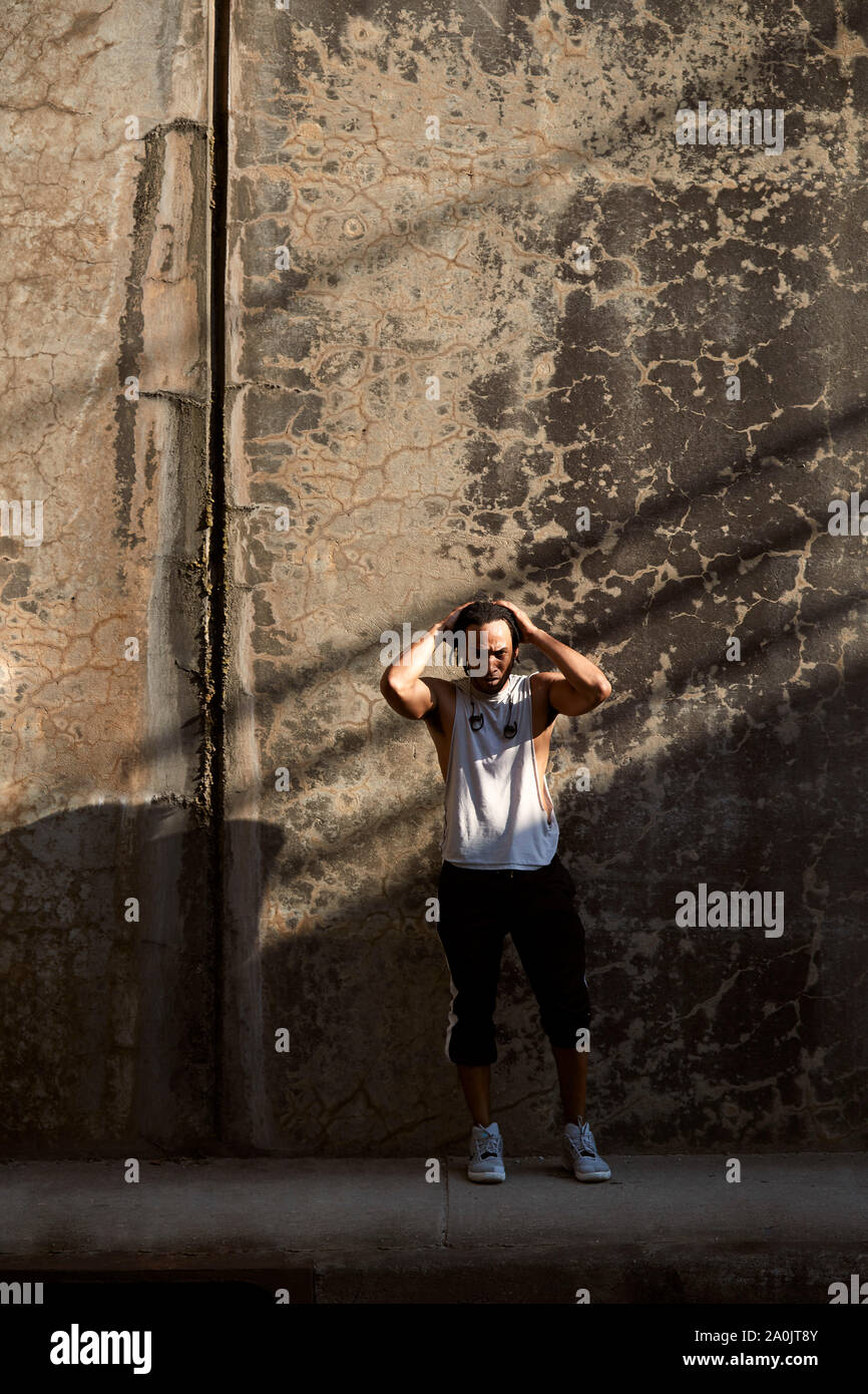 African-American man pulling back dreadlocks after running Stock Photo ...