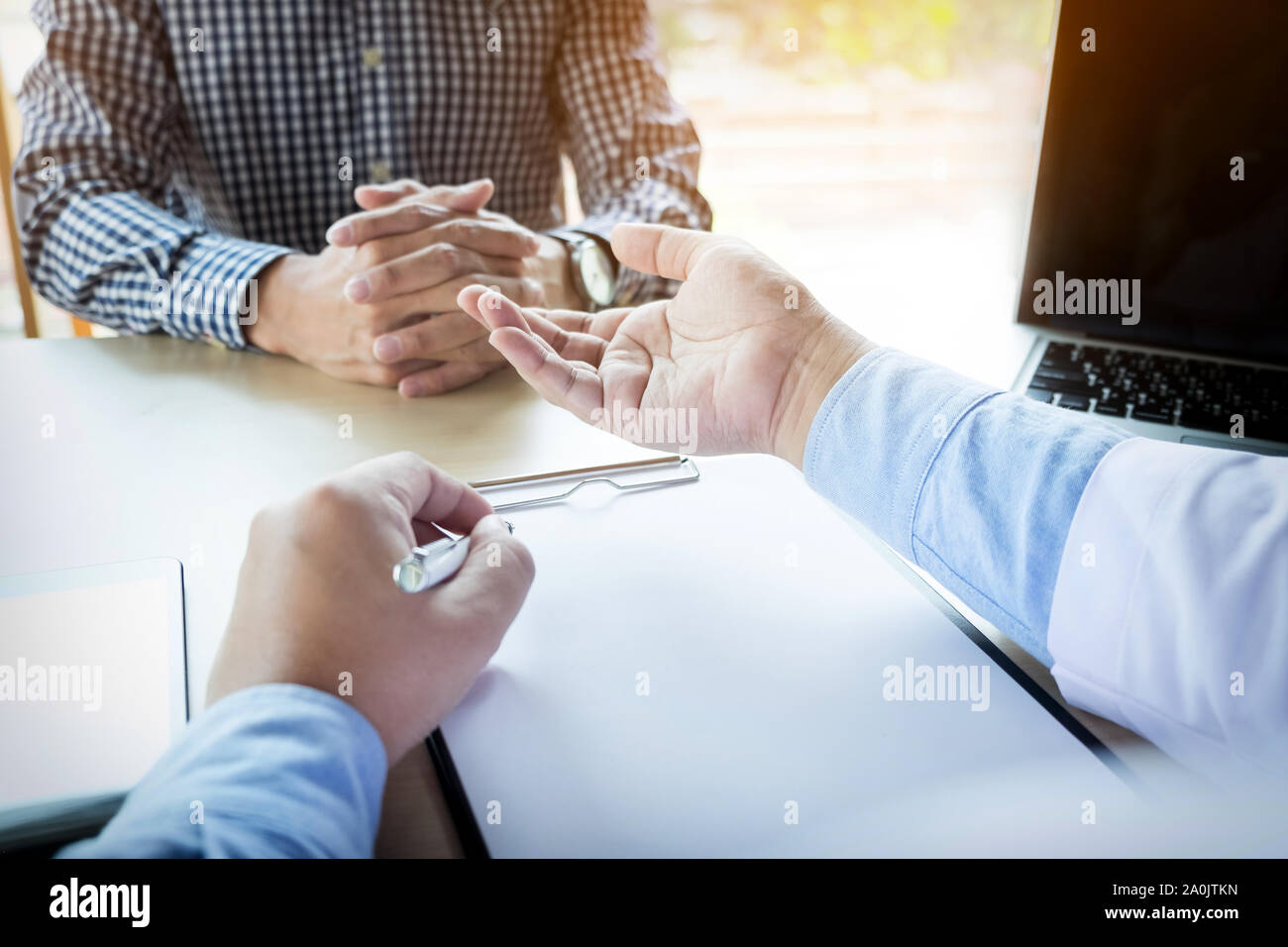 patient listening intently to a male doctor explaining patient symptoms ...