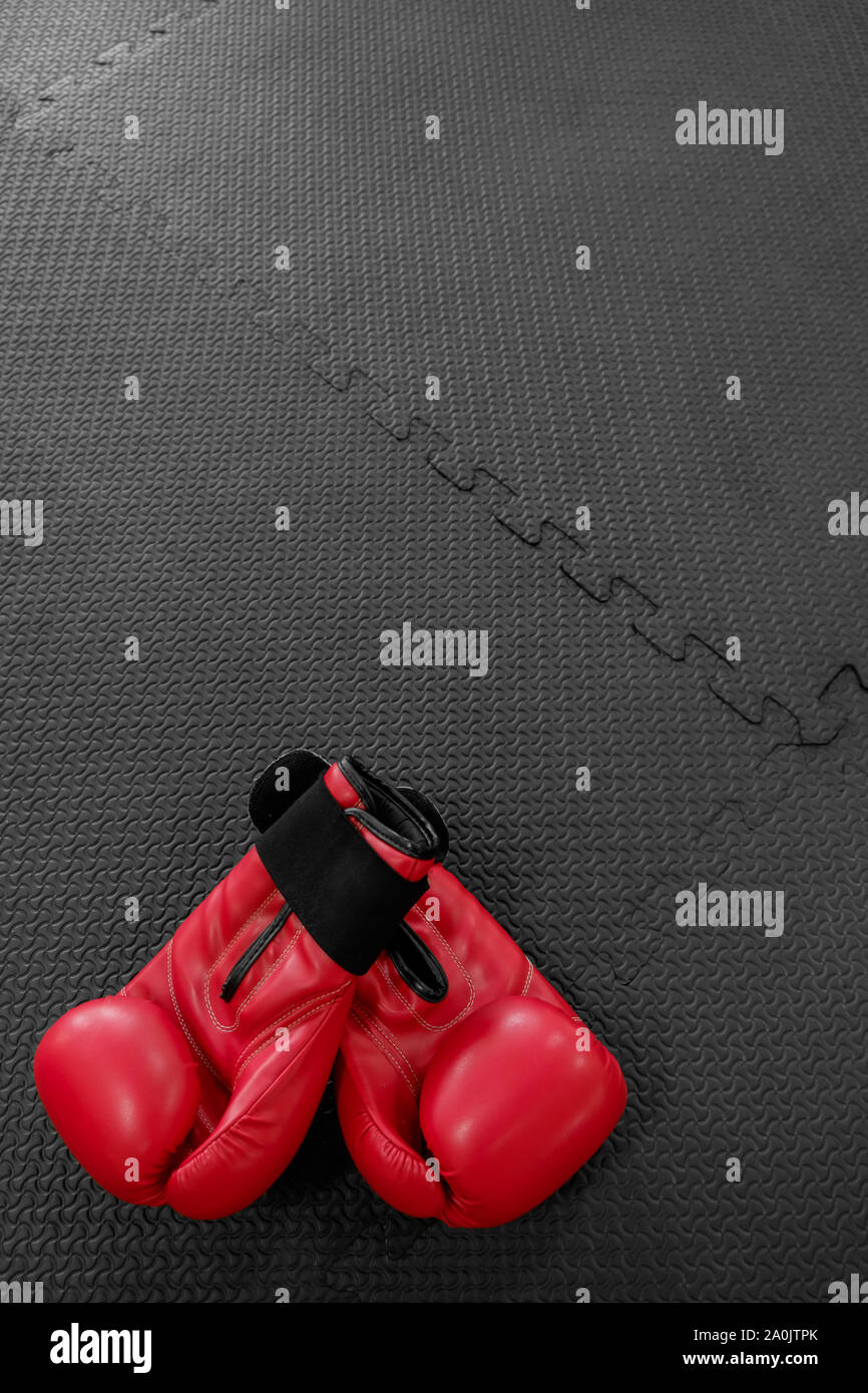 boxing gloves hang on nail on texture wall with copy space for text ...