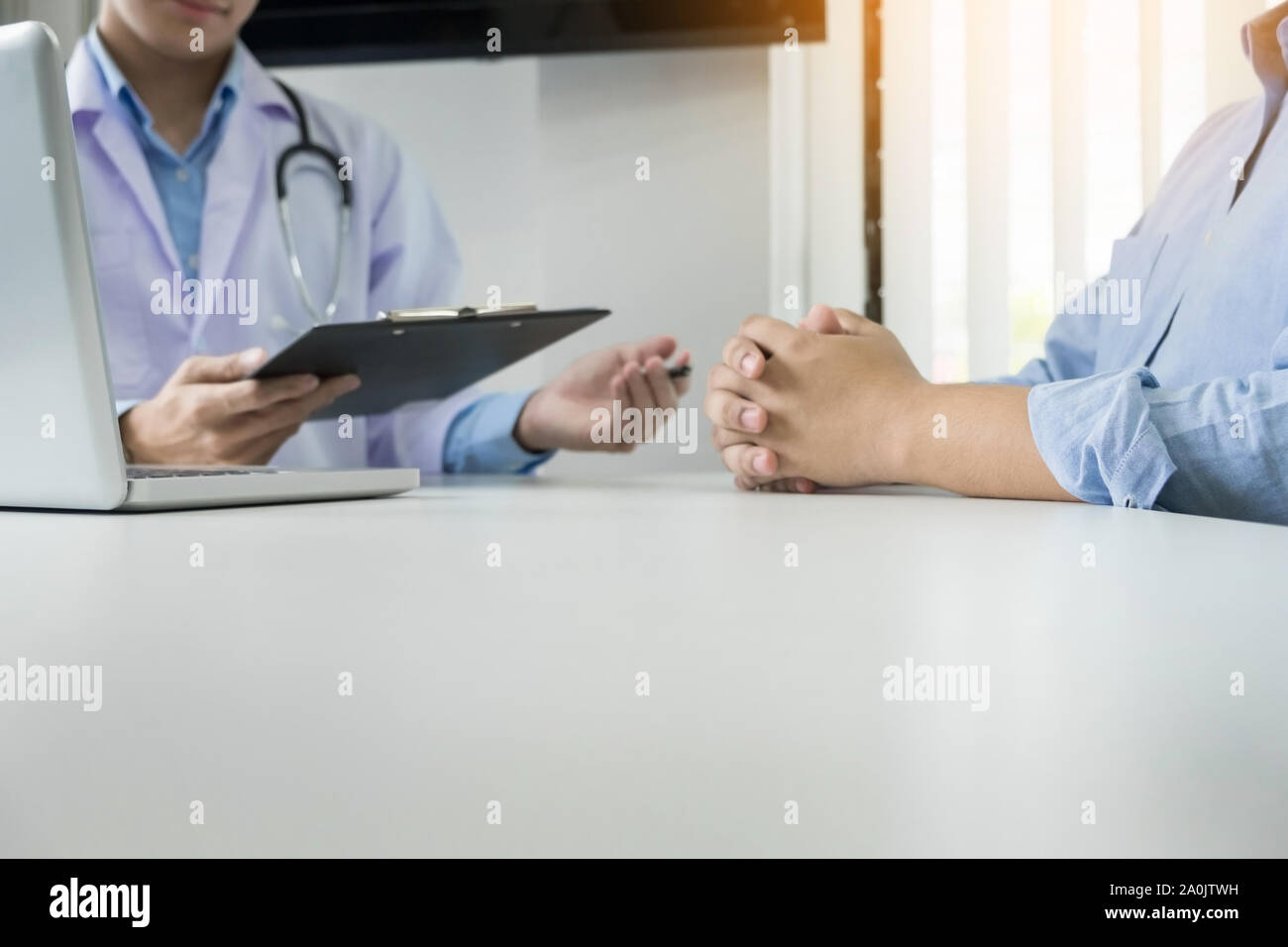 patient listening intently to a male doctor explaining patient symptoms ...