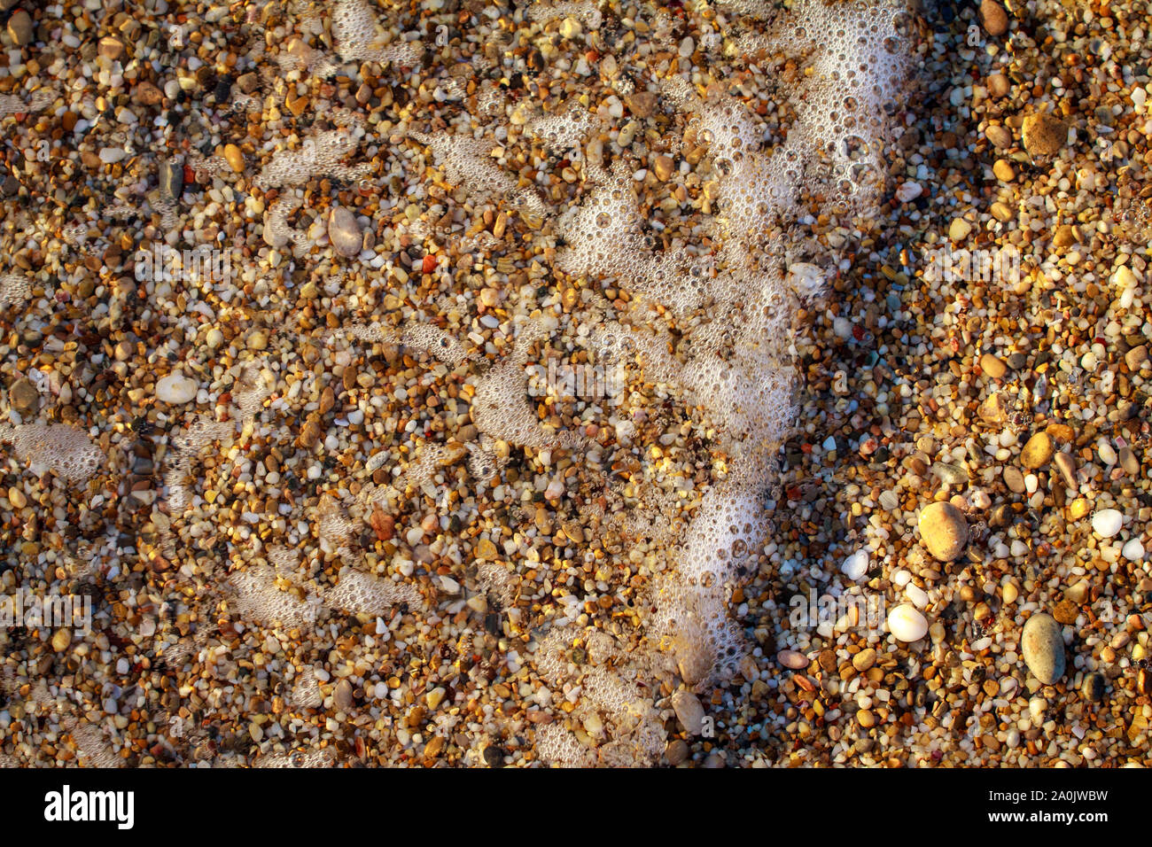 sea pebbles colored granite on the beach background stones. The shore ...