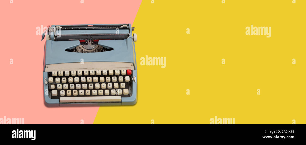 Vintage typewriter over a pastel background with copy space banner ...