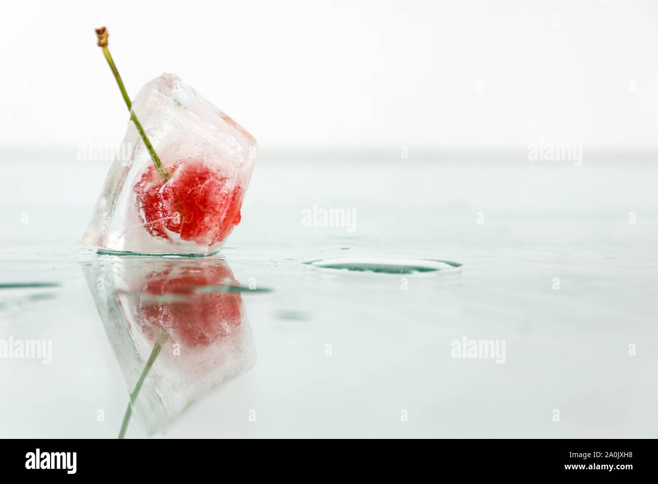 Cherry berry frozen in ice cube. Berry iceberg. Romance decoration ...