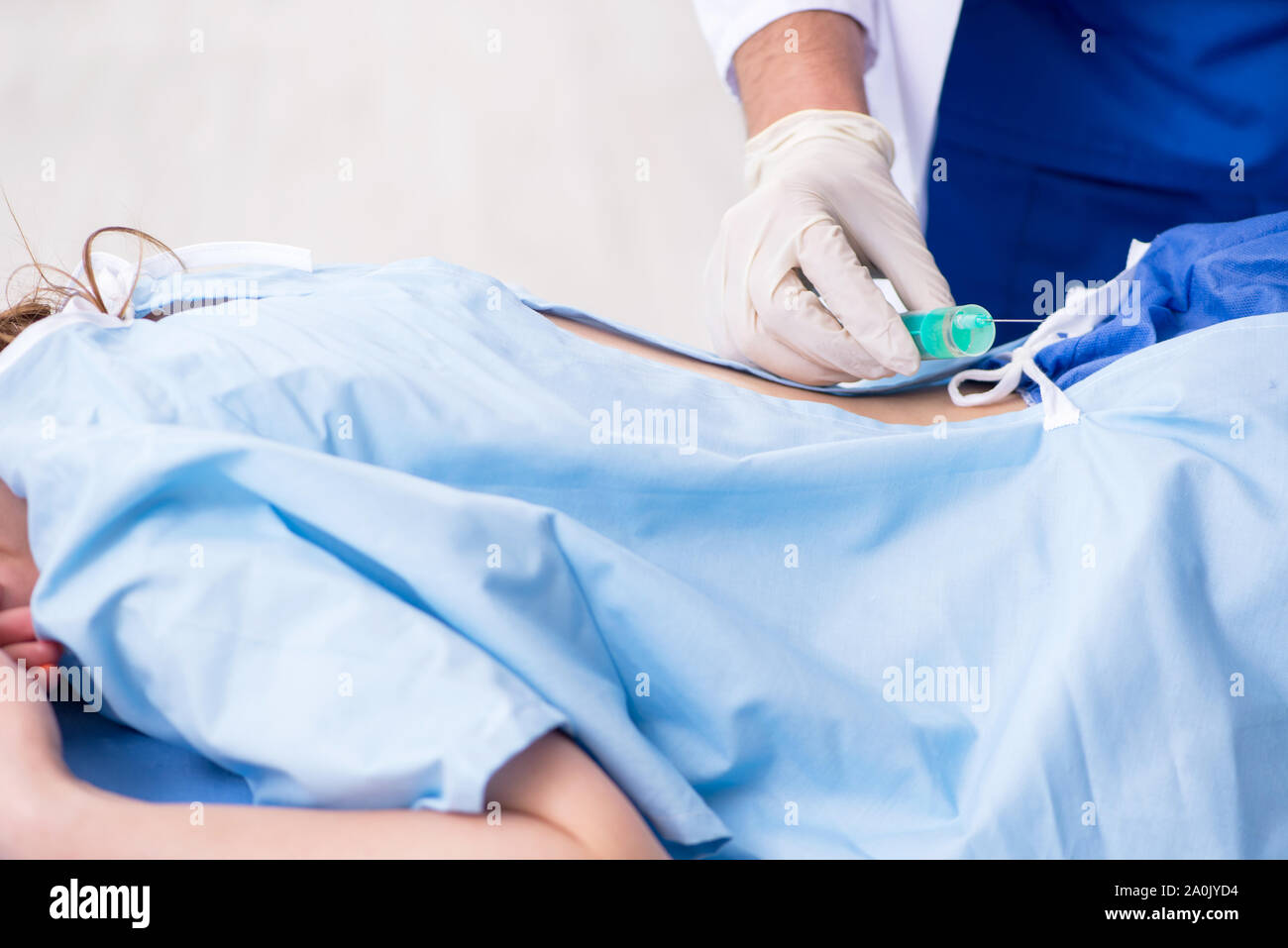 The female patient getting an injection in the clinic Stock Photo - Alamy