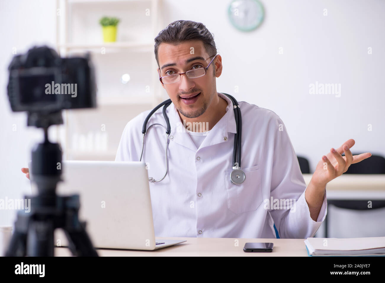 The young male doctor recording video for his blog Stock Photo - Alamy