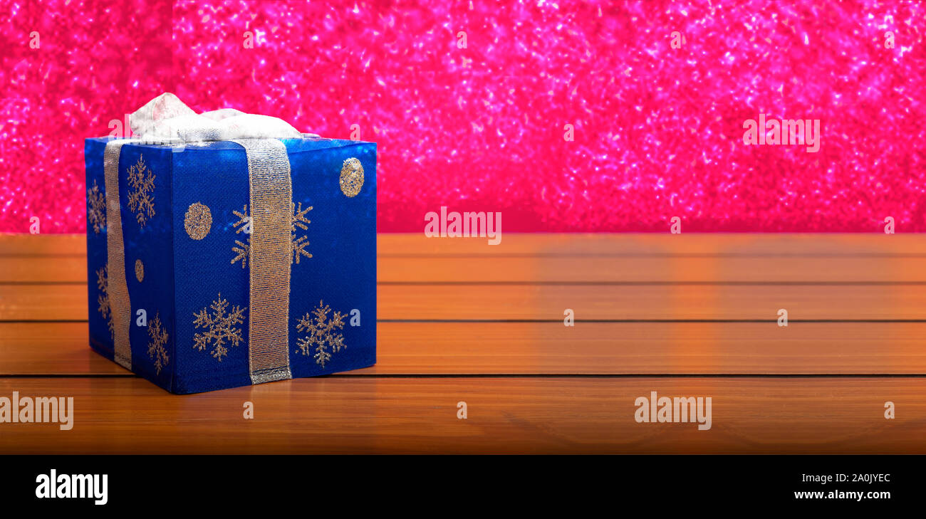 Blue color Christmas gift box with snow on Wooden background, copy ...