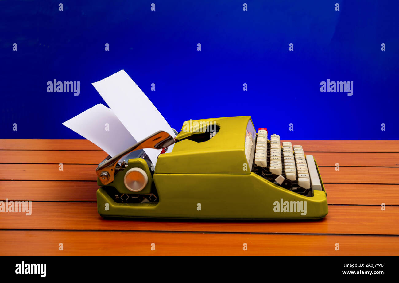 Old manual typewriter with white paper on wooden table, copy space ...