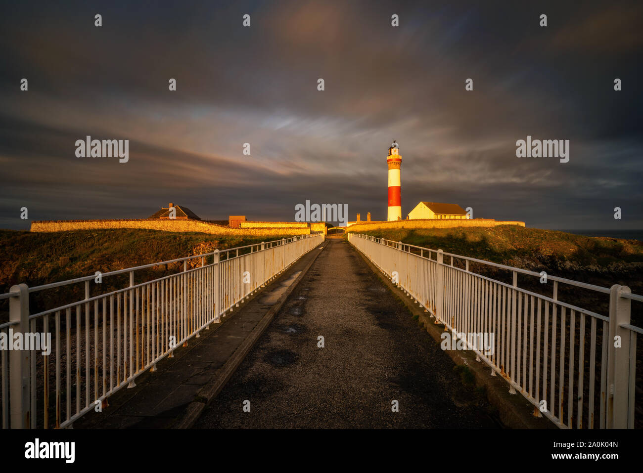 Buchaness Lighthouse with bridge before in sunset light, Scotland Stock ...