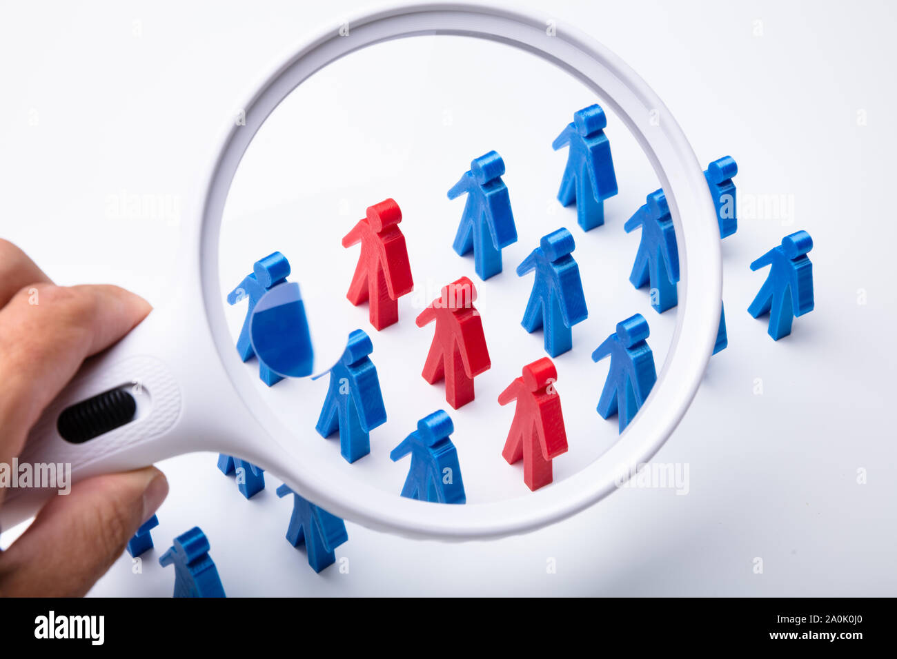 Close-up Of Human Hand Holding Magnifying Glass Over Red And Blue Human ...