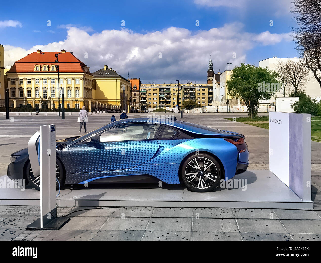 Electric vehicle being plugged in Stock Photo - Alamy