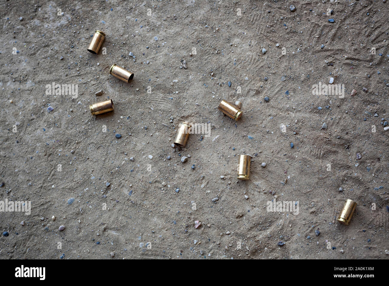 9 mm empty bullet shells lying on desert dirt with some rocks Stock ...