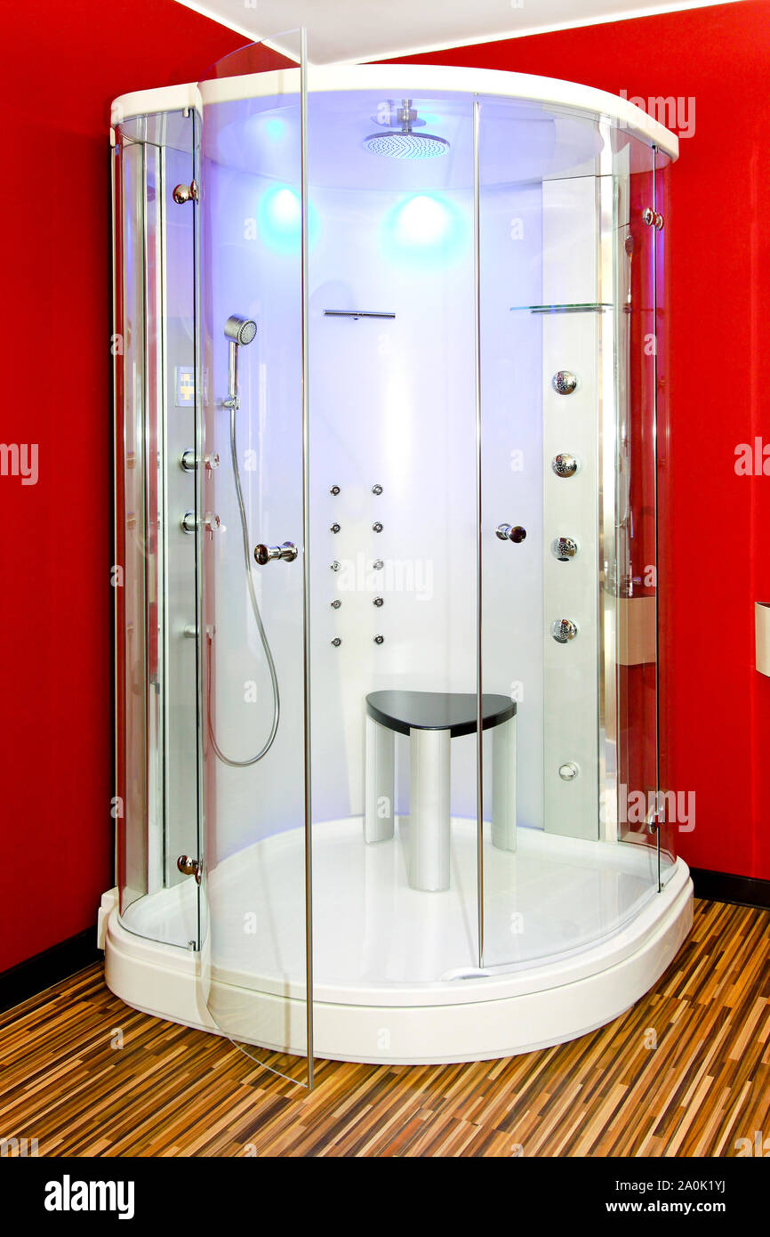 Shower cabin with hydro jets in red bathroom Stock Photo - Alamy