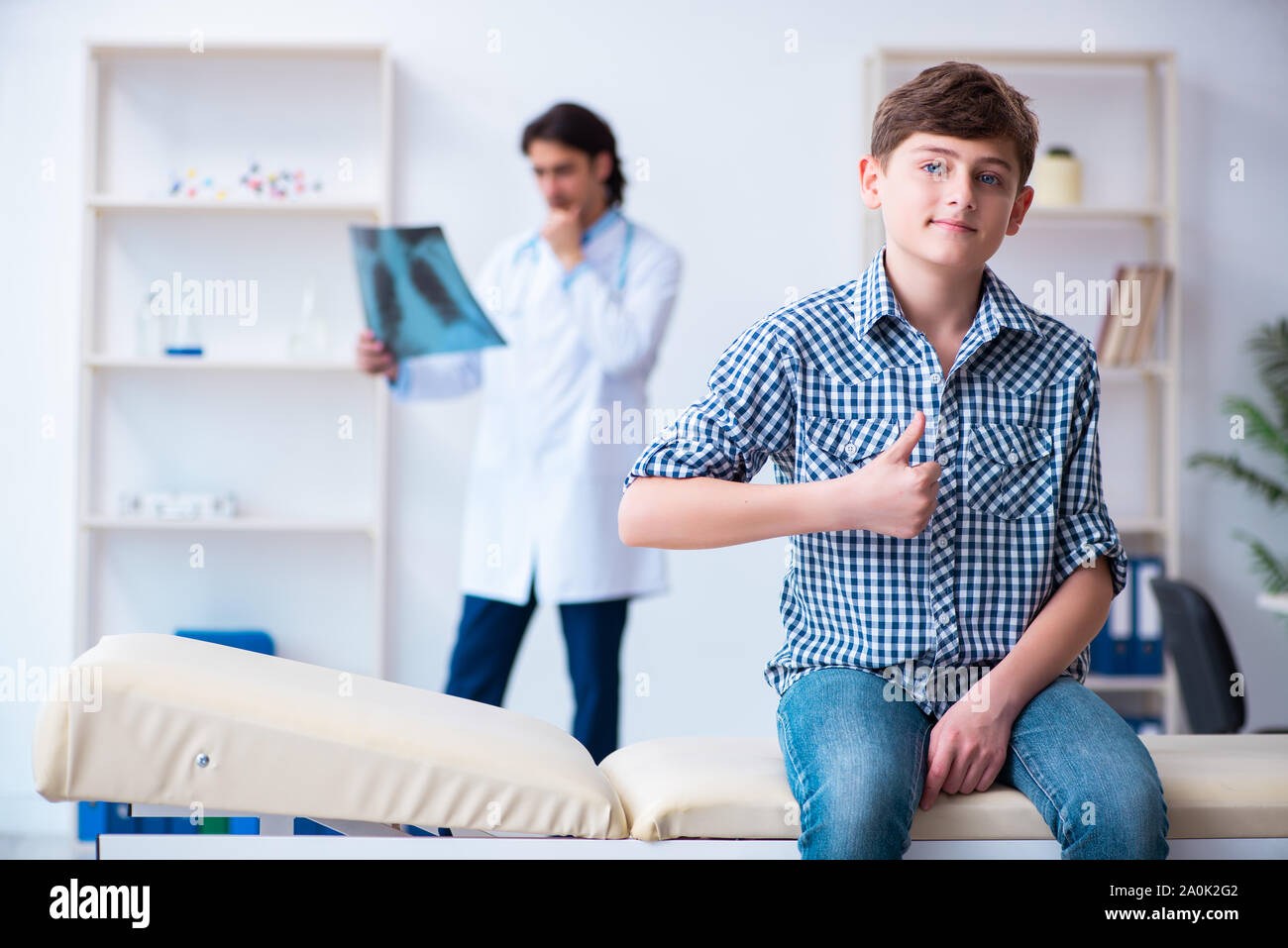 The male radiologist looking at boy's images Stock Photo - Alamy