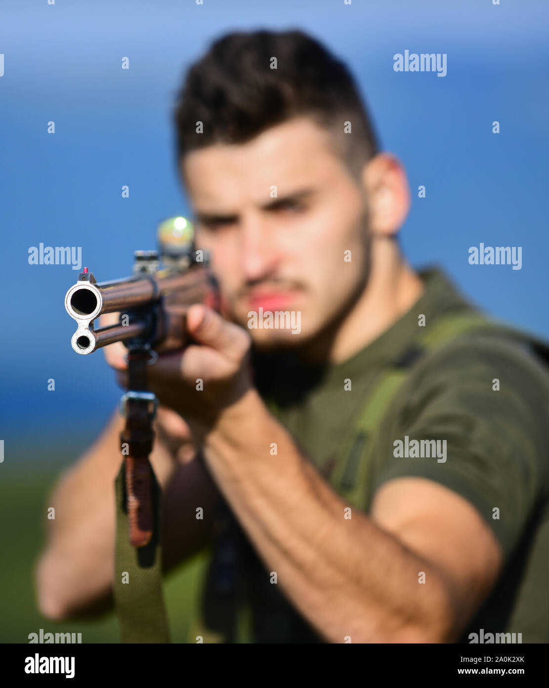 Hunter handsome guy with weapon. Safety measures. Natural environment ...