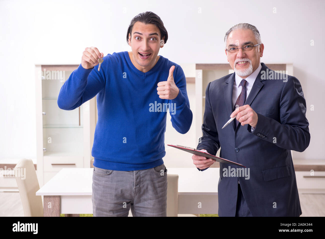The male real estate agent and male client in the apartment Stock Photo ...